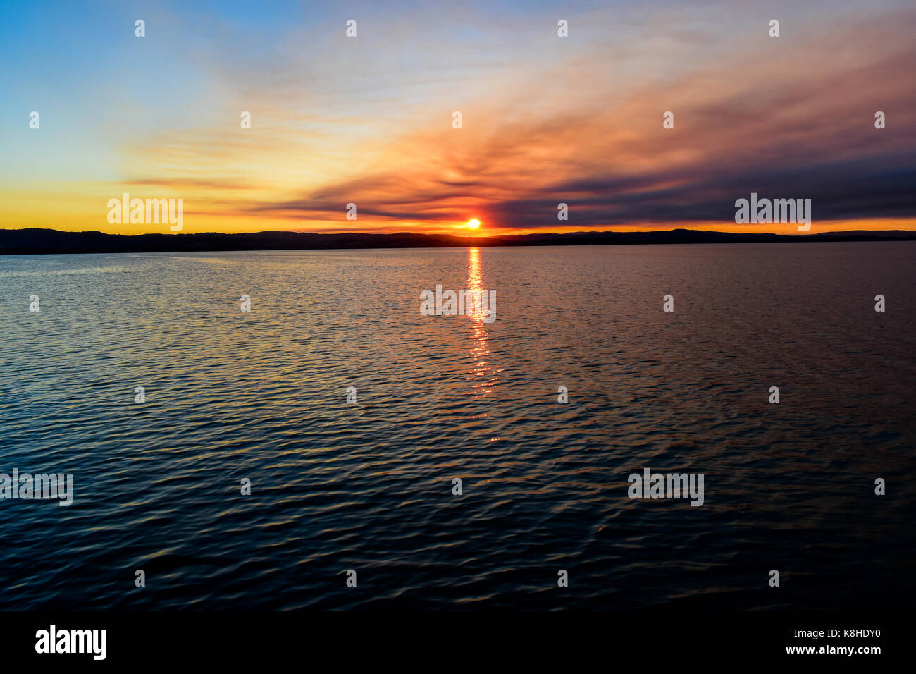 Watching the sunset on Long Jetty, NSW Australia Stock Photo - Alamy