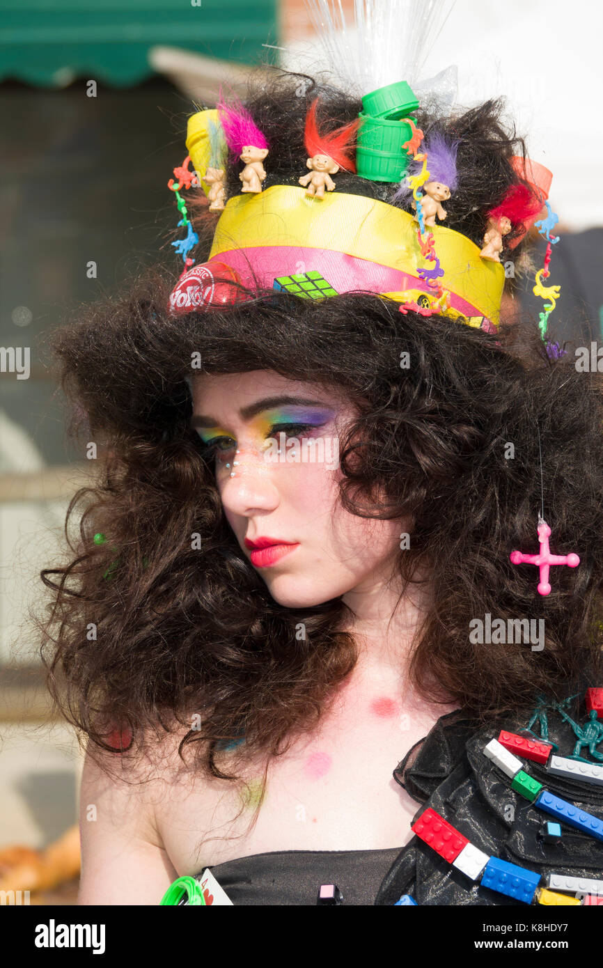 Colorful and beautiful young woman model posing as a human manikin ...