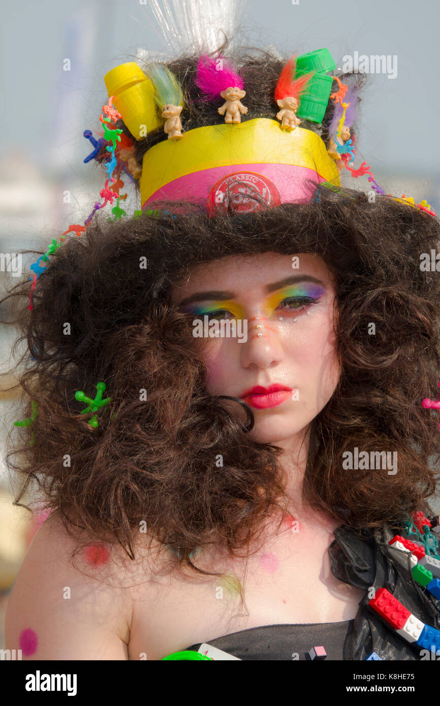 Colorful and beautiful young woman model posing as a human manikin ...