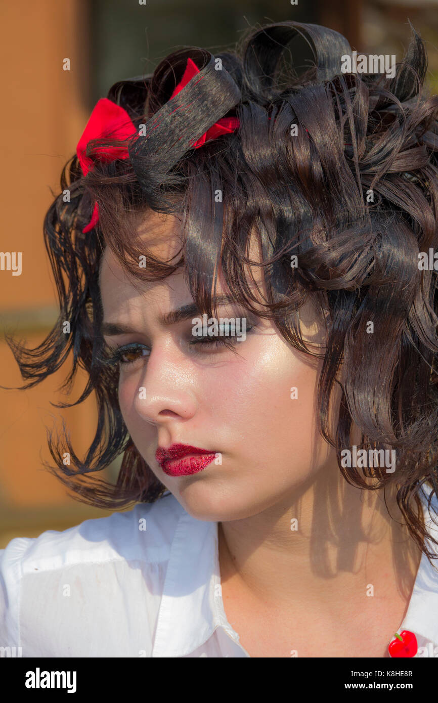 Colorful and beautiful young woman model posing as a human manikin ...