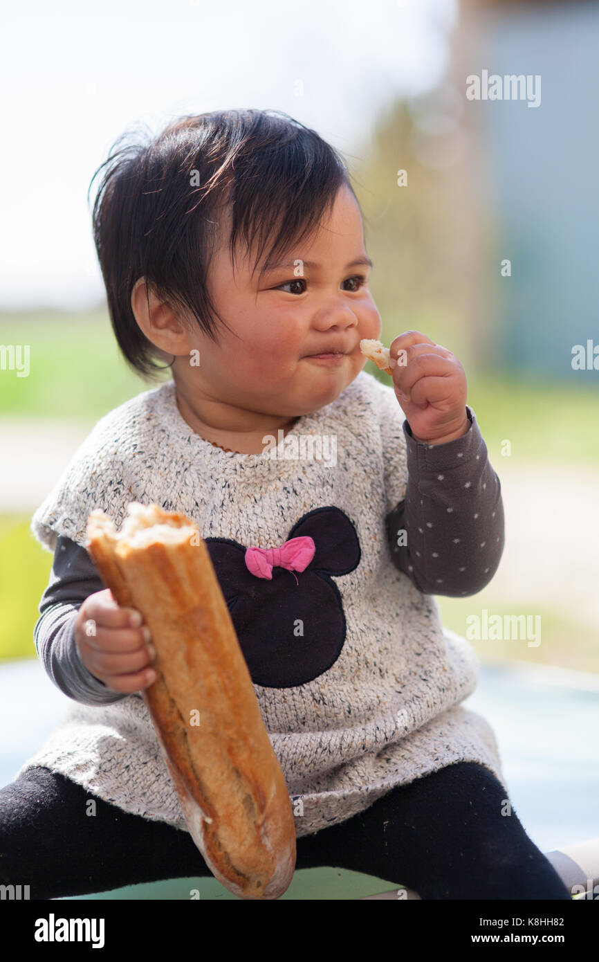 Infant eating bread hi-res stock photography and images - Alamy