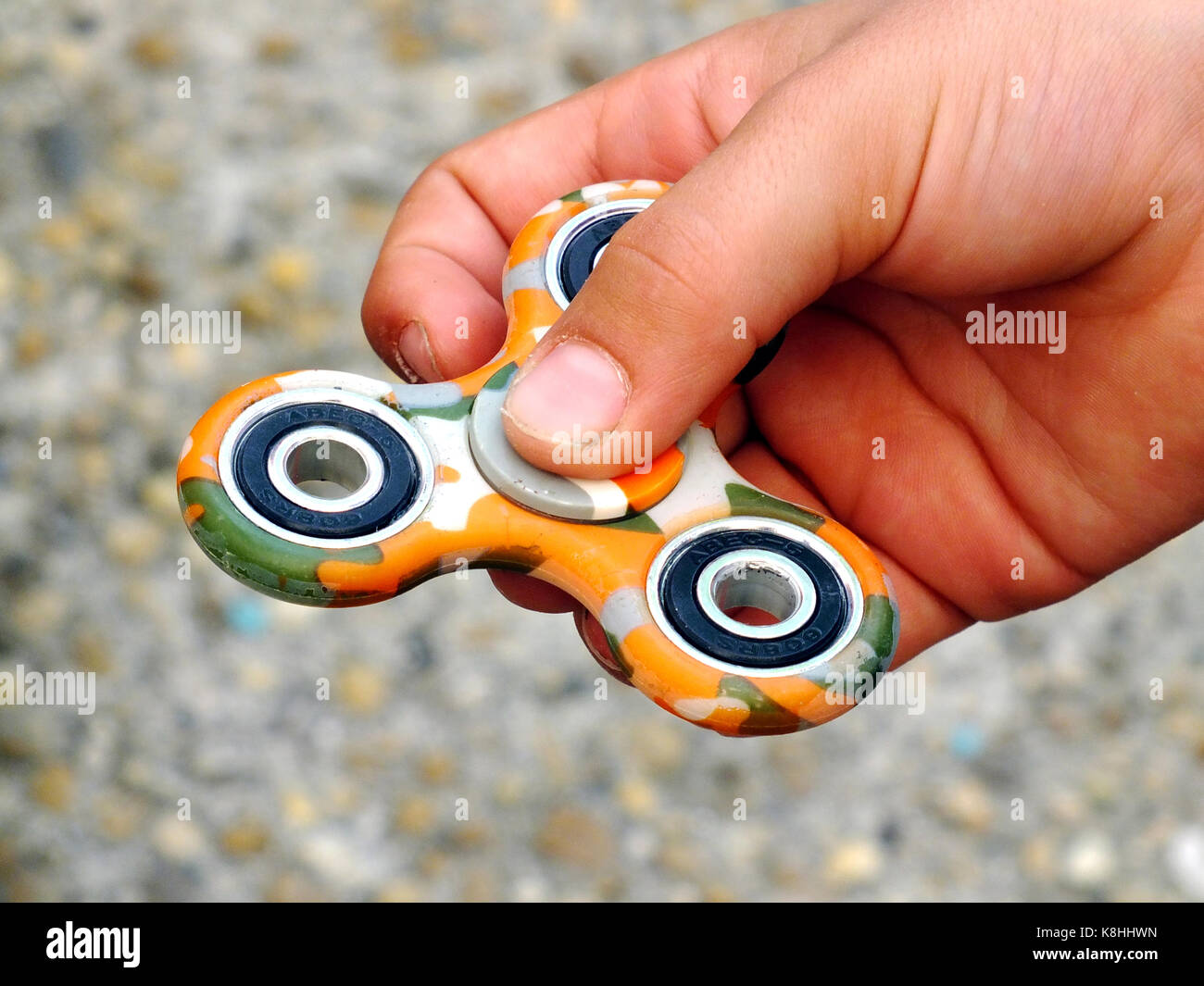 Boys playing with fidget spinner hi-res stock photography and images ...