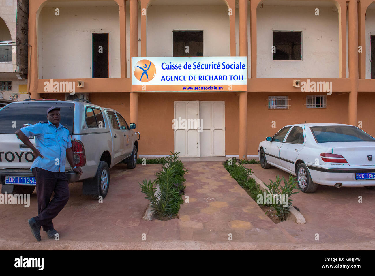 Watchman outside an office. senegal Stock Photo - Alamy