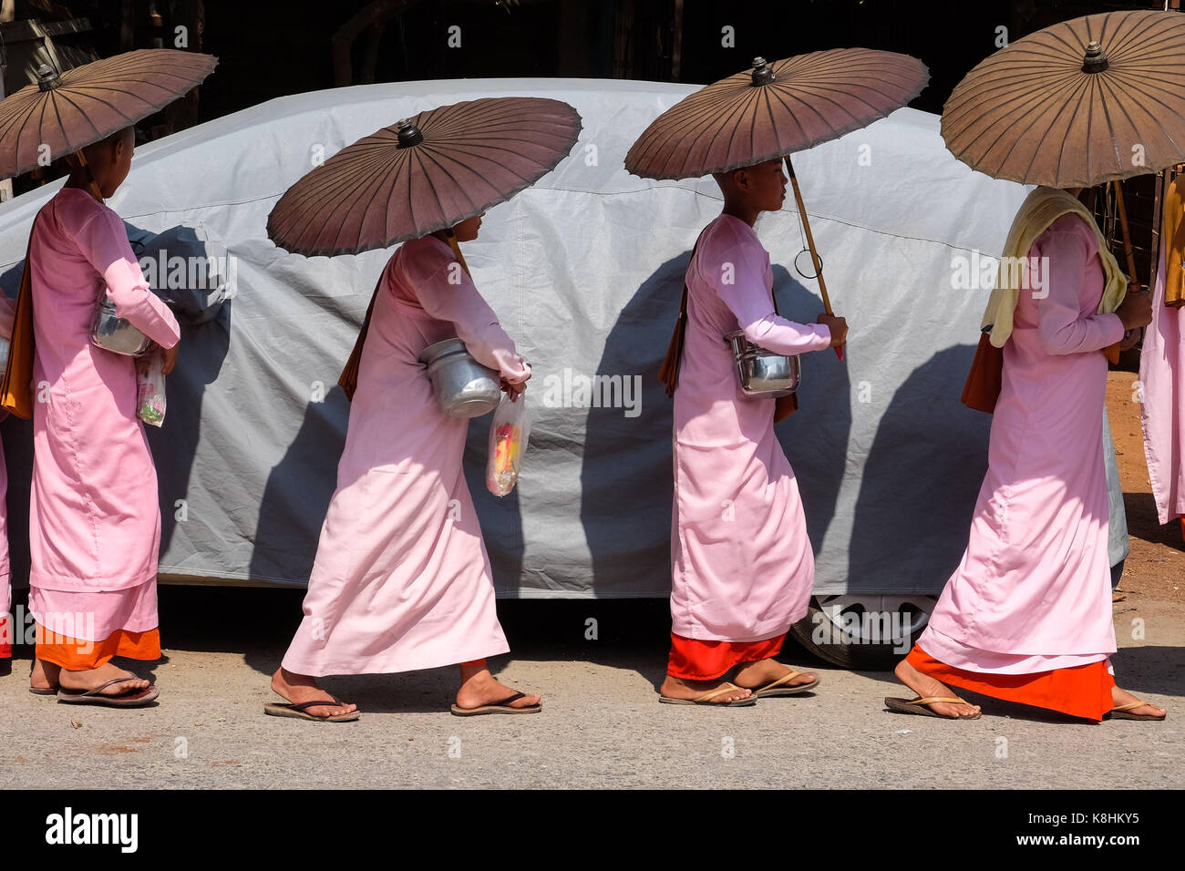 Burma, Myanmar: young Buddhist nuns, wearing pink tunics and holding ...