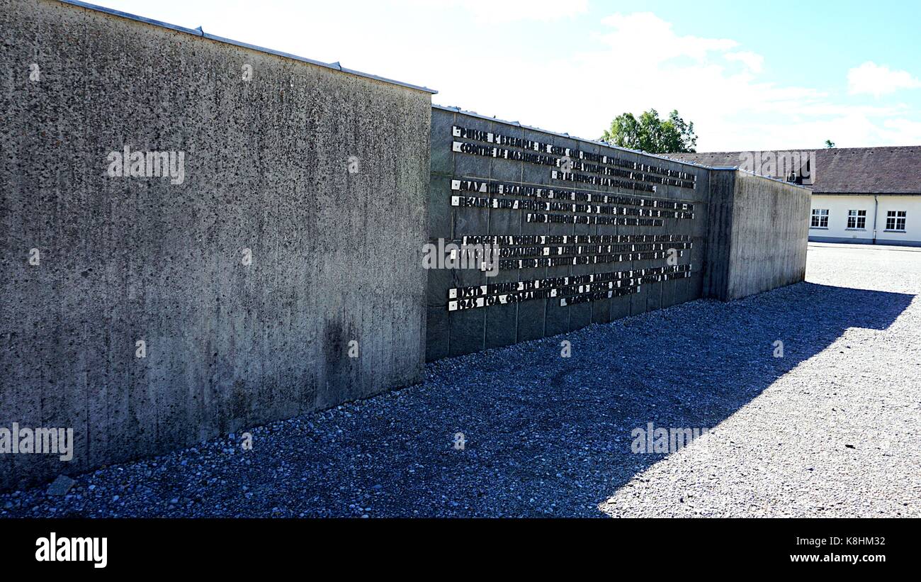 A memorial wall "Never again" written in several languages in Dachau ...