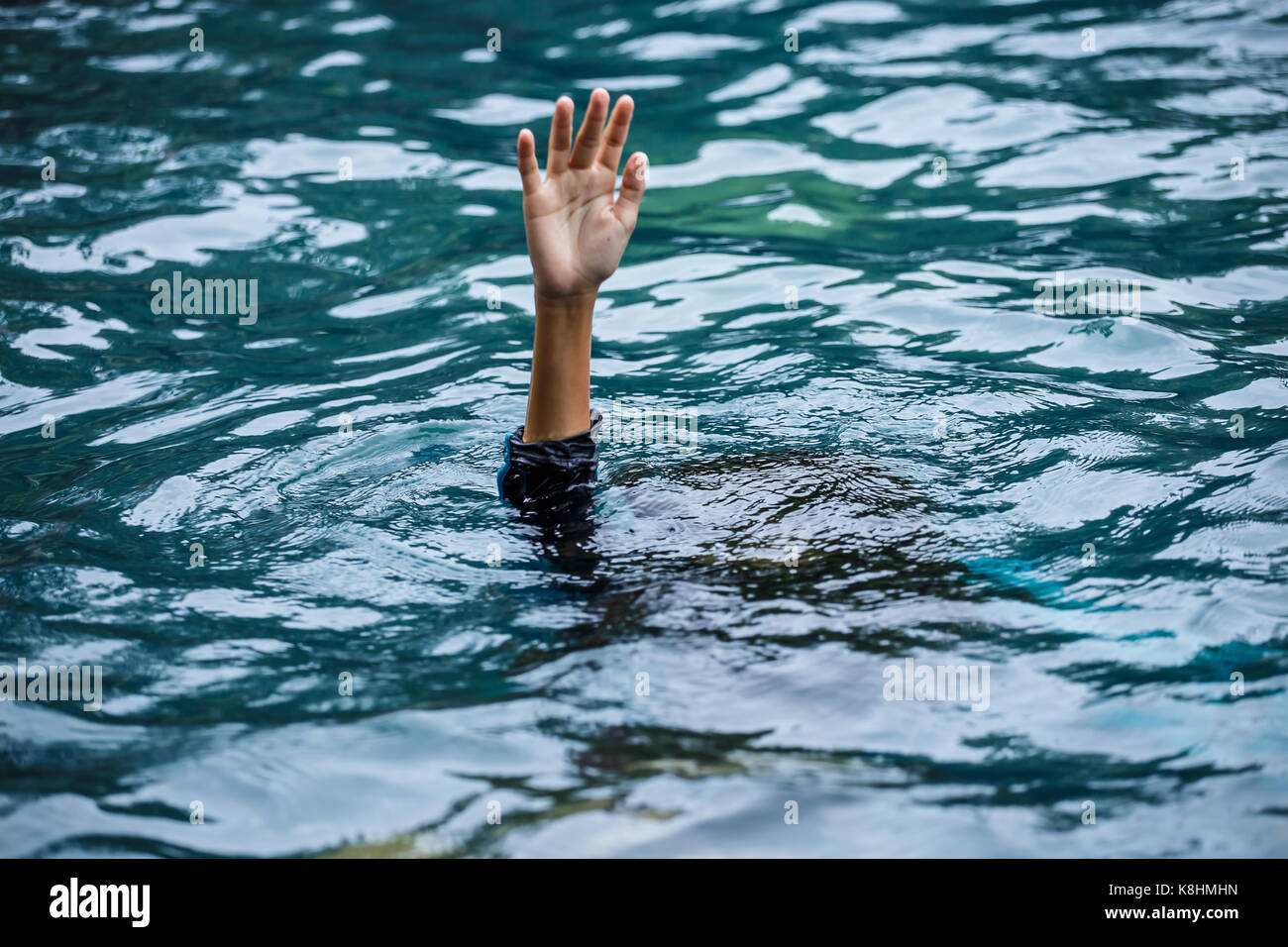 Drowning people raise hands for help in the pool Stock Photo - Alamy