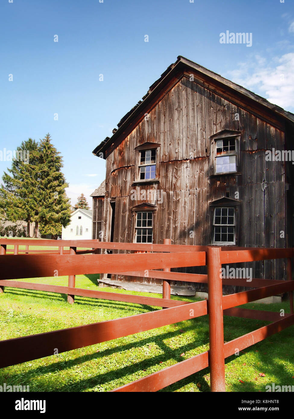 old barn with red fence vertical Stock Photo - Alamy