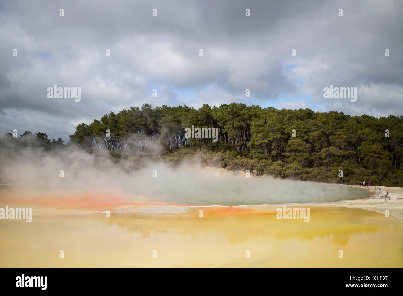 Idyllic view of hot spring by trees against cloudy sky Stock Photo - Alamy