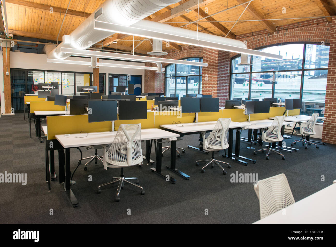 Trendy modern open concept loft office space with big windows, natural light and a layout to ...