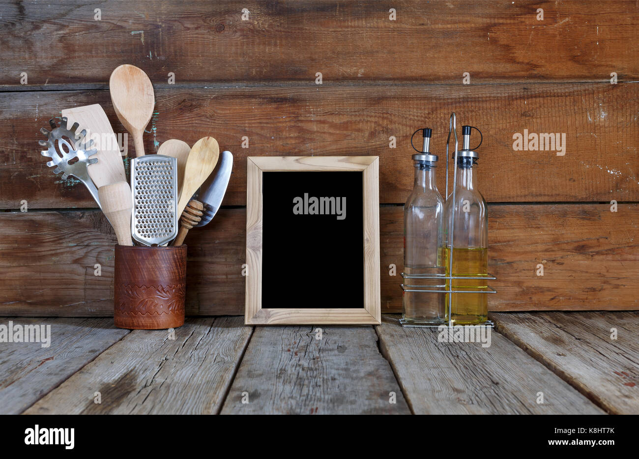 Kitchen still life. Kitchen utensils in a stand near the wooden wall ...