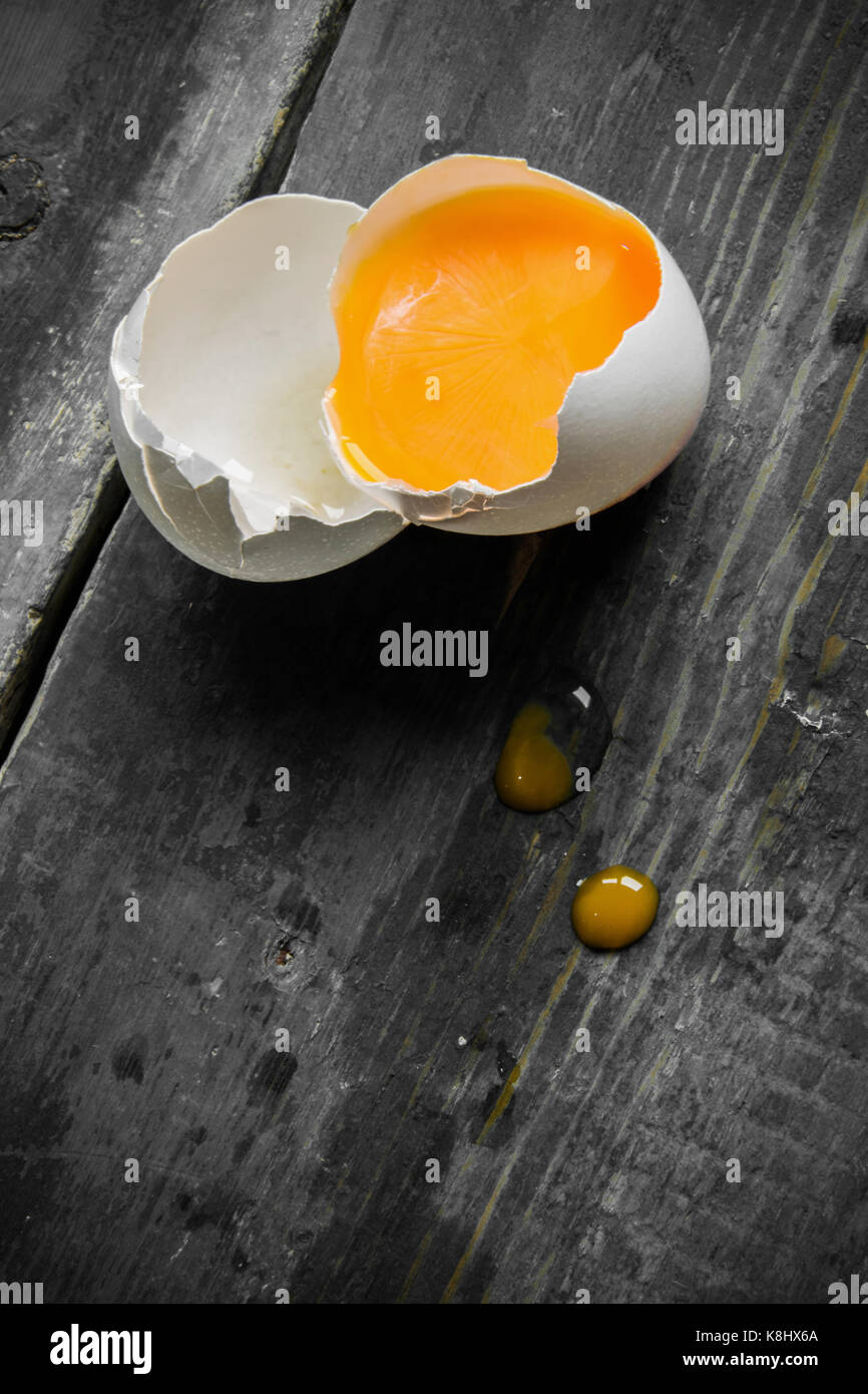Top view of broken egg on wooden table Stock Photo - Alamy