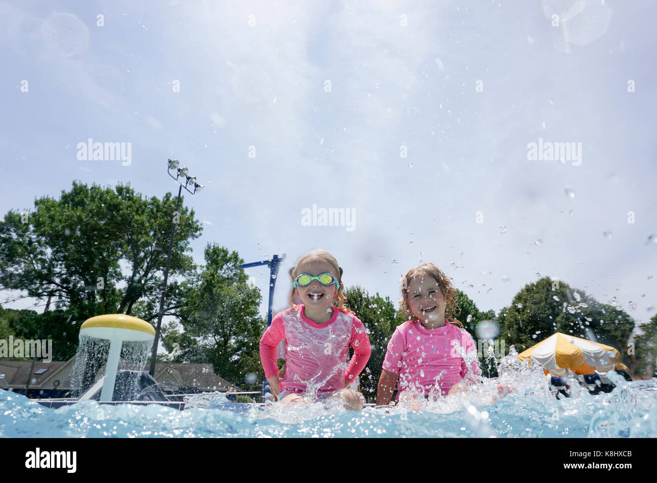 Family sitting swimming pool hi-res stock photography and images - Alamy