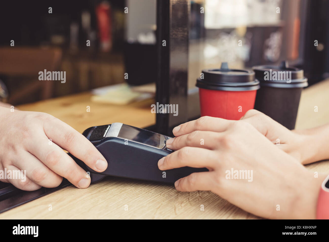 Person using pos terminal at the cafe Stock Photo - Alamy