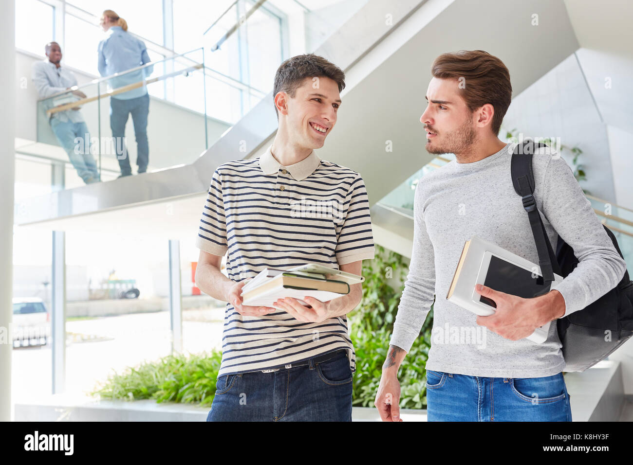 Two students stand together as friends in school or university Stock ...
