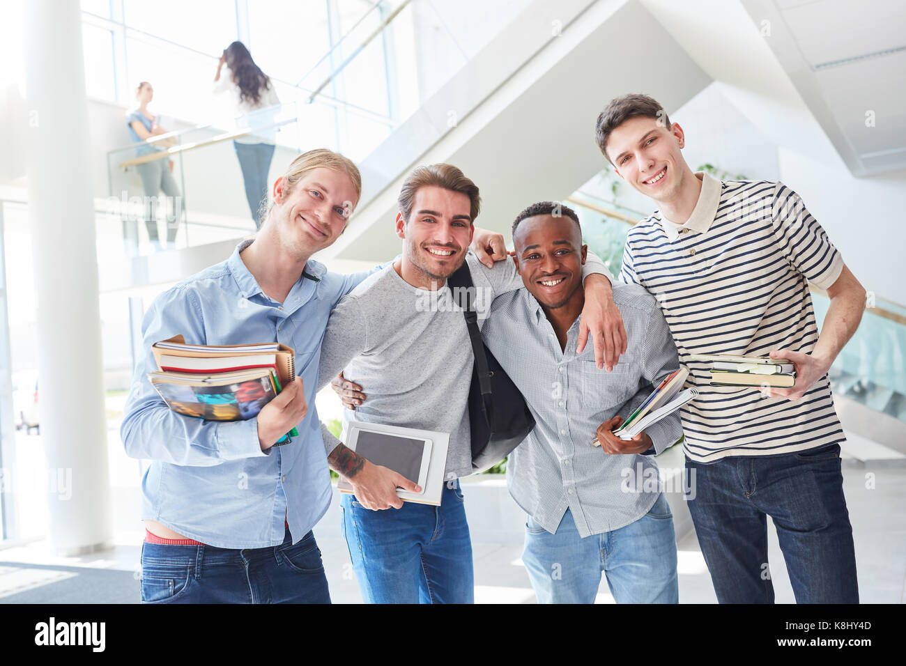 Students as friends in interracial team at university Stock Photo - Alamy