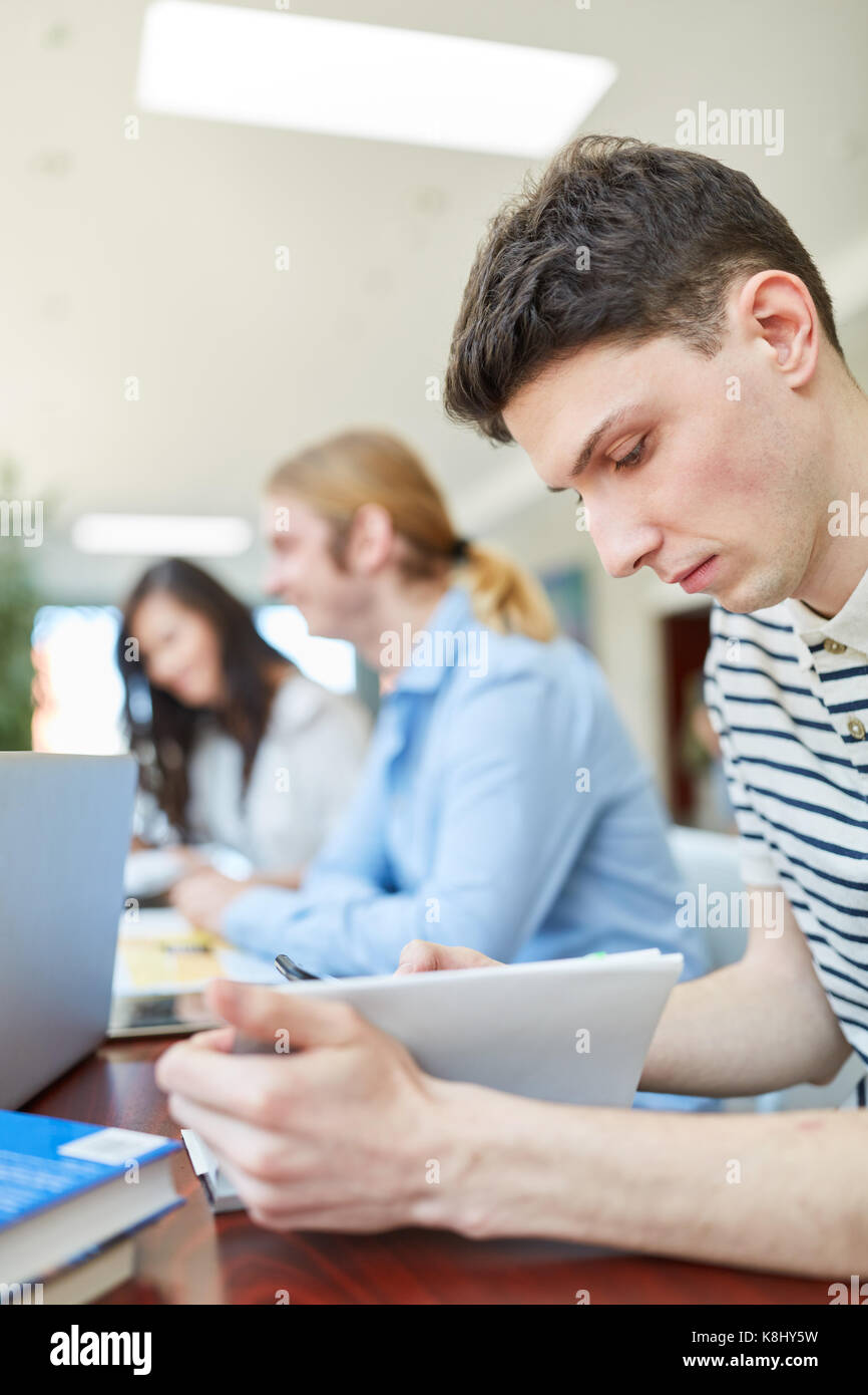Concentrated young student studyinig with team of students Stock Photo ...