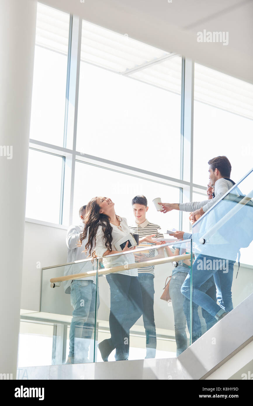 Students as friends having fun in university stairs Stock Photo - Alamy