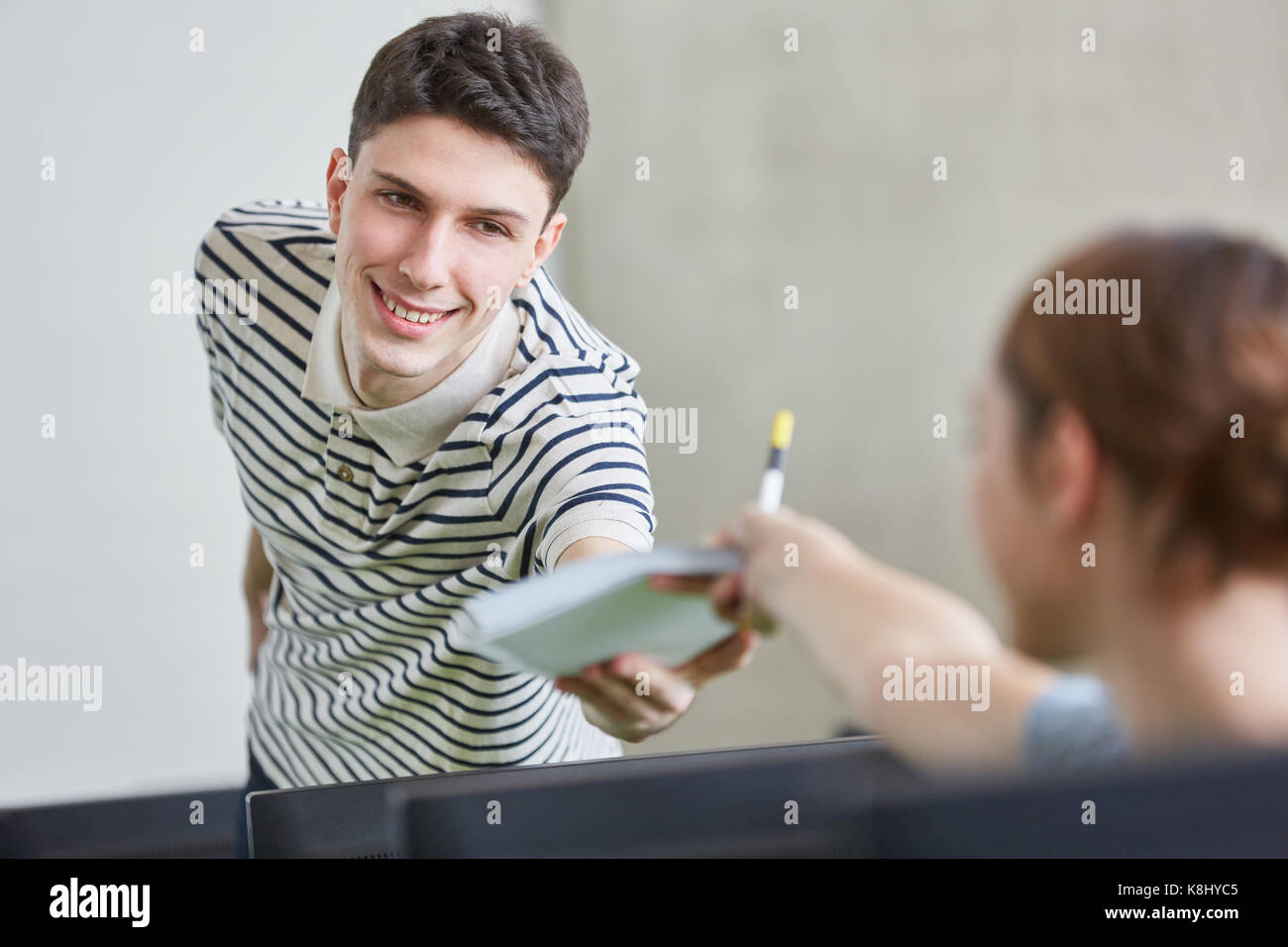 Students teamwork in university with help and notes sharing Stock Photo ...