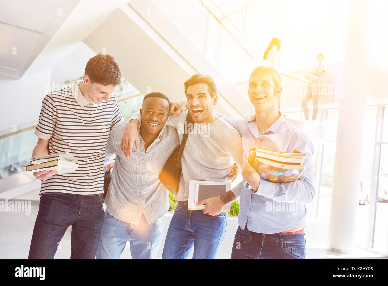Men in laughing group of students and friends in university Stock Photo ...
