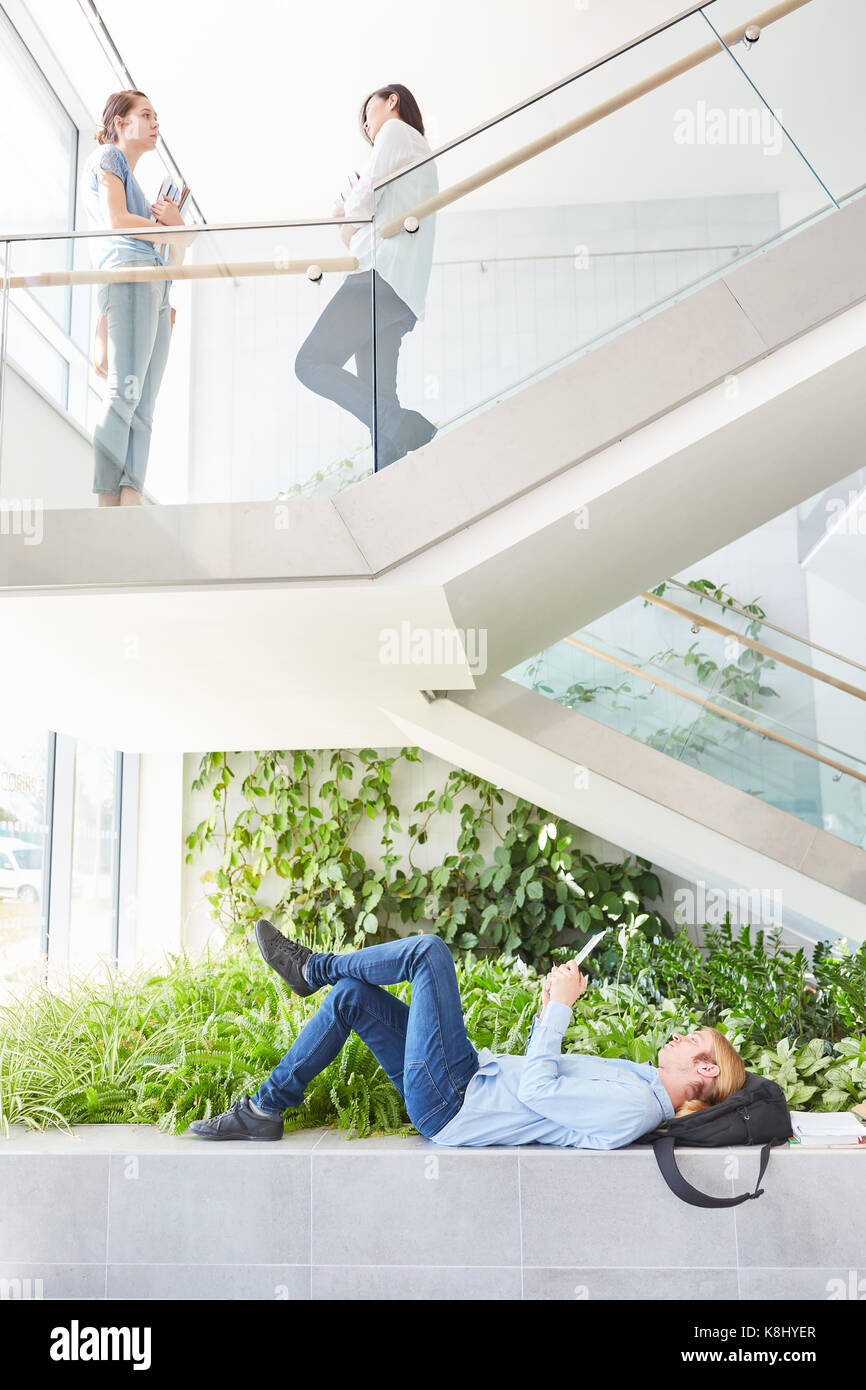 Uni students taking a break in school after class Stock Photo - Alamy