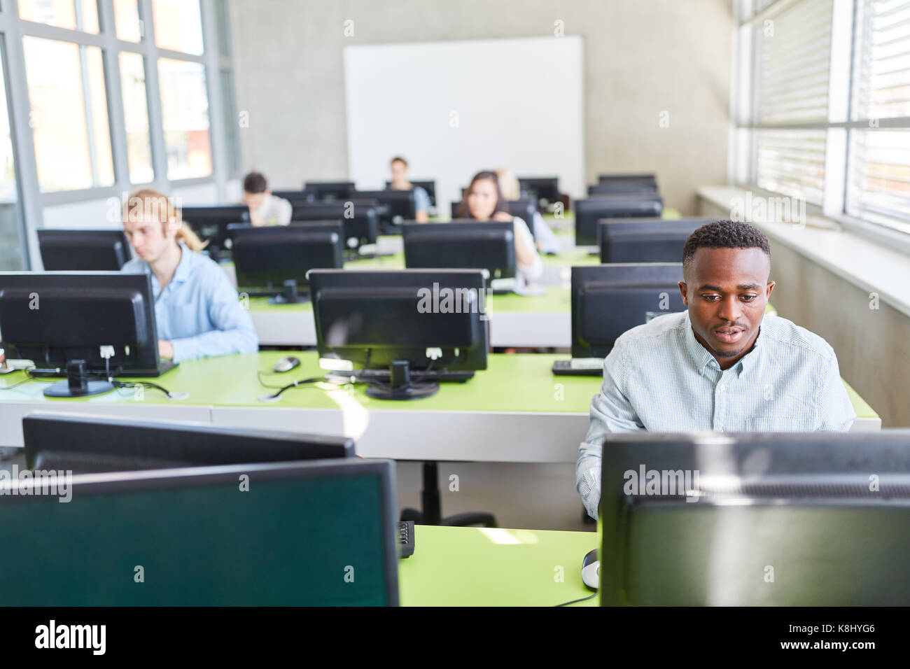 Group of students in e-learning seminar in computer room Stock Photo ...