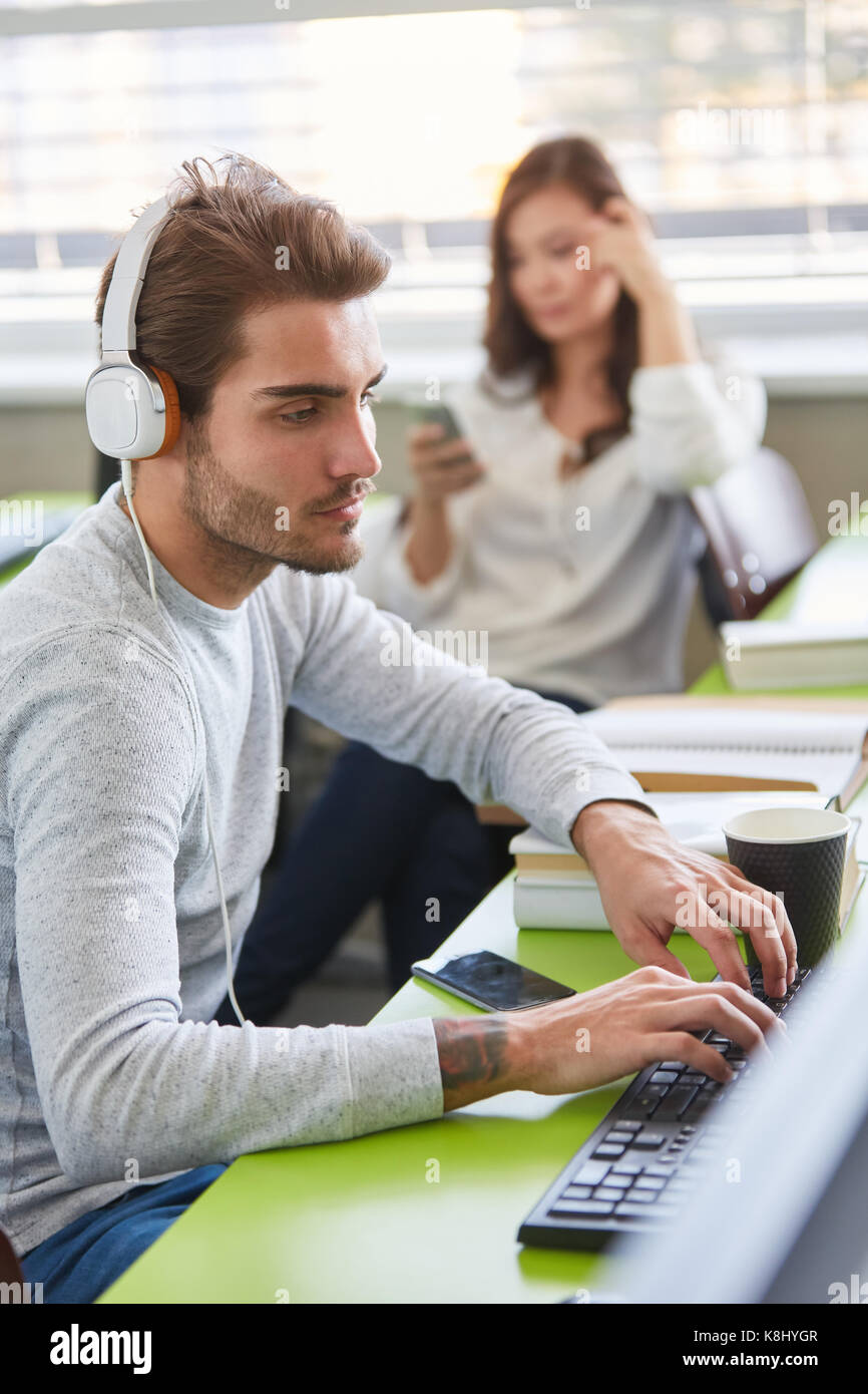 Man as student and programmer works with PC in university Stock Photo ...