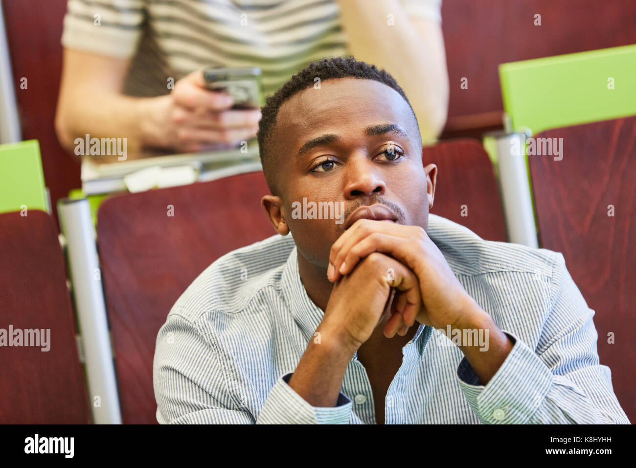 African man as student thinking during university lecture Stock Photo ...