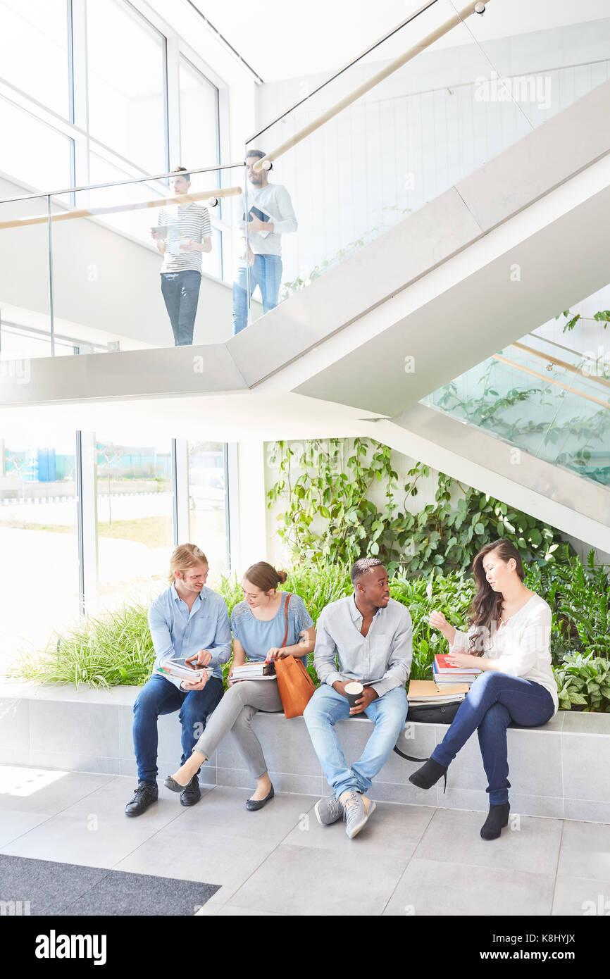 Students making small talk in school at university campus Stock Photo ...