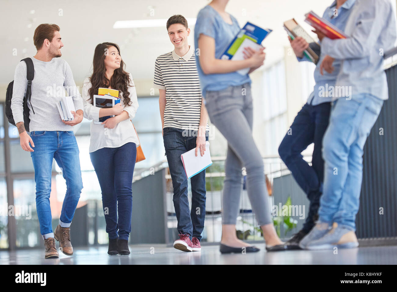 Students in university hallway during class break Stock Photo - Alamy