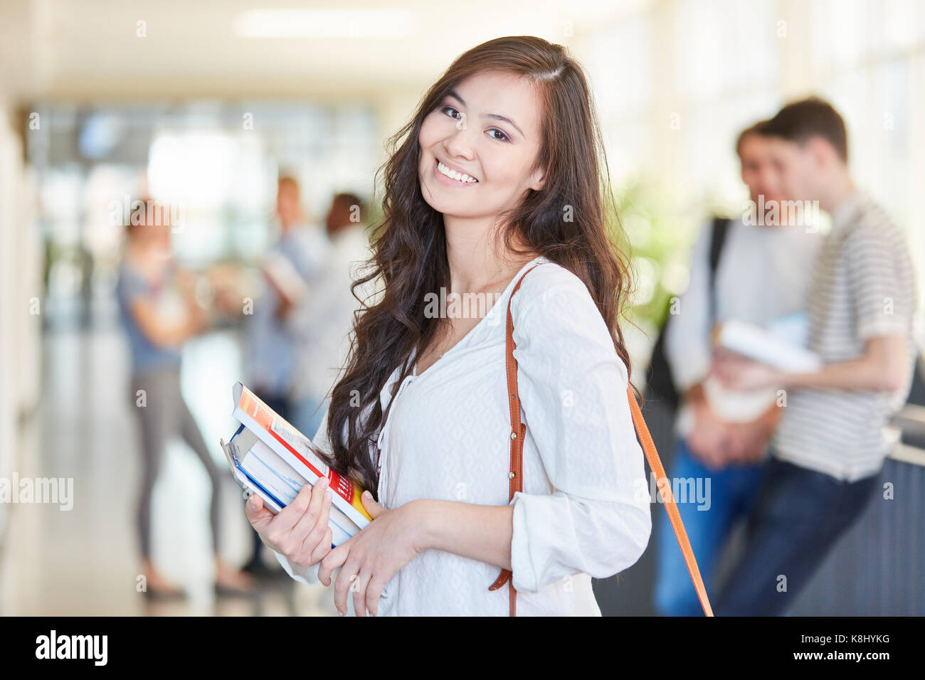 Woman as happy asian student in the uni Stock Photo - Alamy
