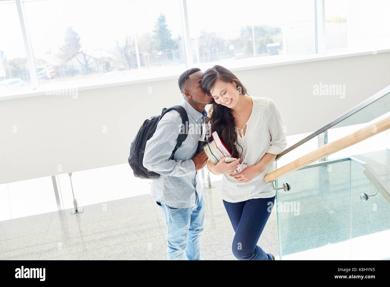 Happy students as couple in love in university Stock Photo - Alamy