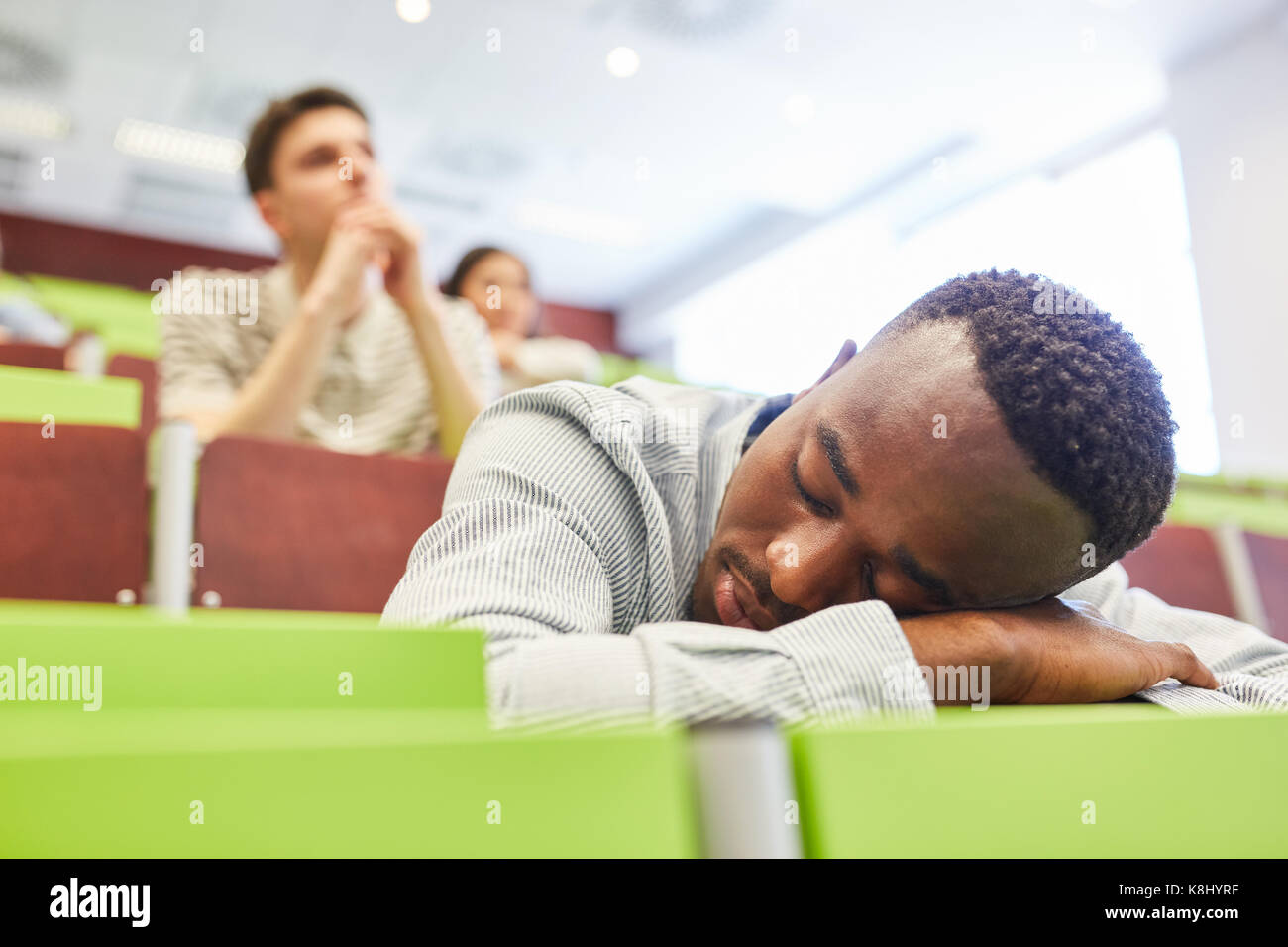 African student with Burnout and sleeps exhausted at lecture hall Stock ...