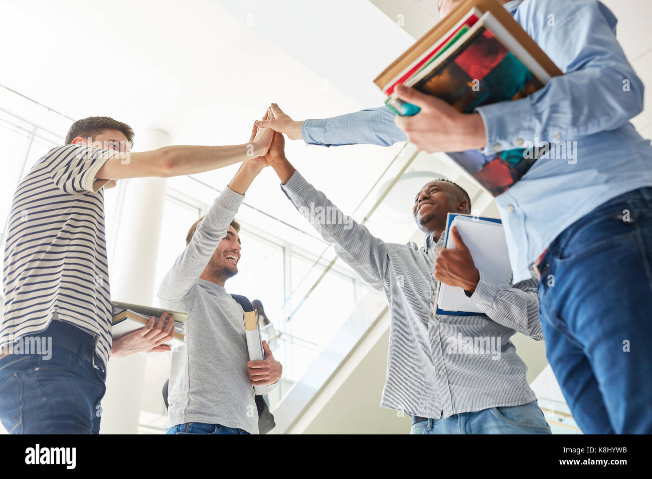 Successful student team shares High Five as teamwork motivation Stock ...