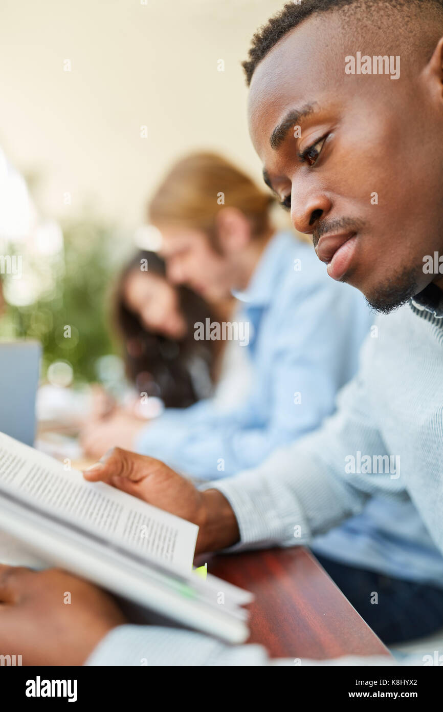 African student reads book for university exam Stock Photo - Alamy