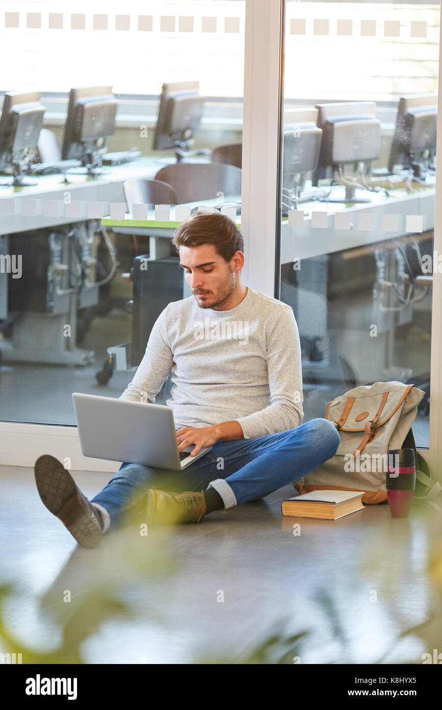 Man as student study with laptop computer online Stock Photo - Alamy