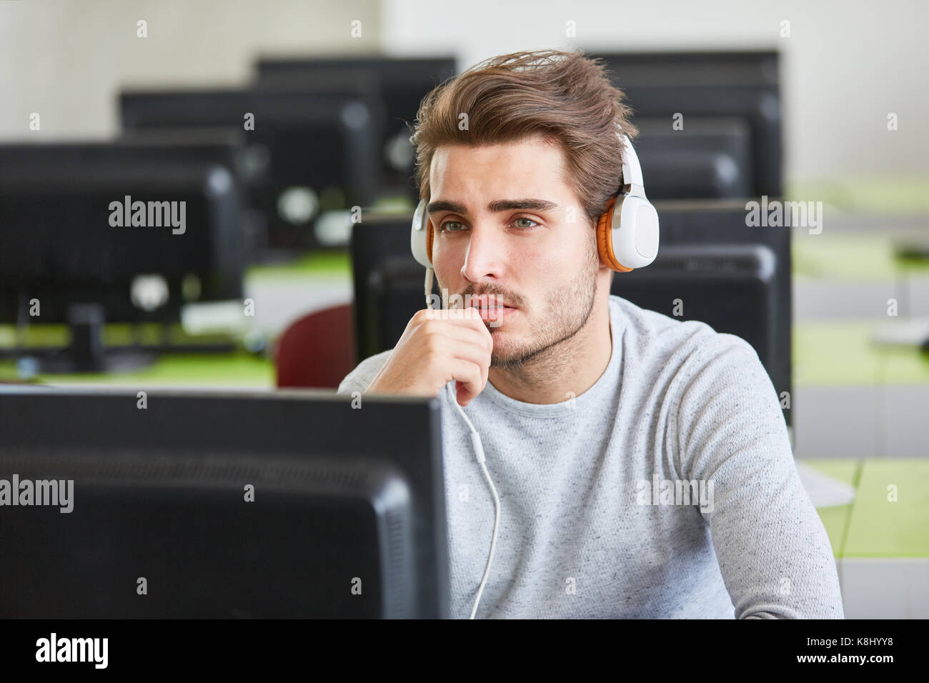 IT student as programmer with computer think about idea Stock Photo - Alamy