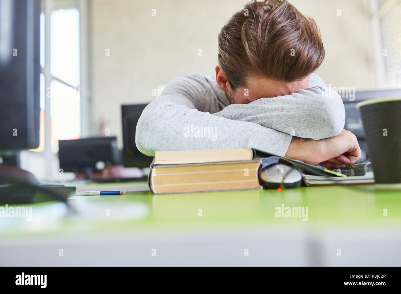 Fatigue student sleeps on his desk and books in classroom Stock Photo ...