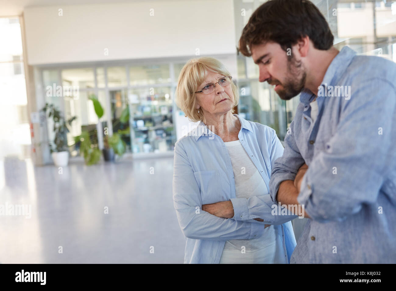 Teacher and lecturer discuss serious problem in school Stock Photo - Alamy