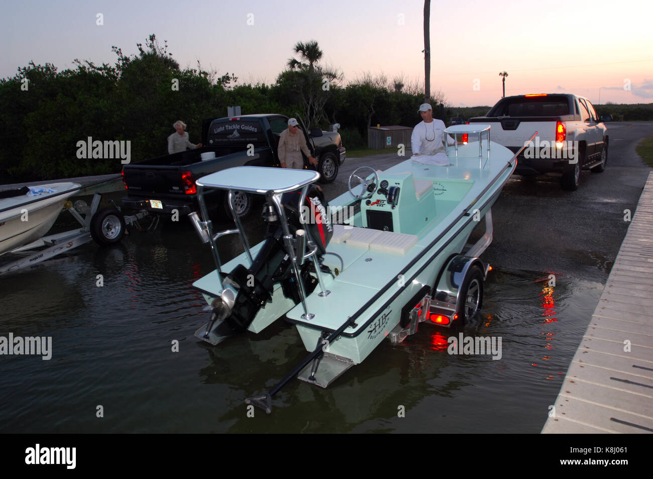 Fishermen launch their fishing boat at sunrise near Mosquito Lagoon, FL ...
