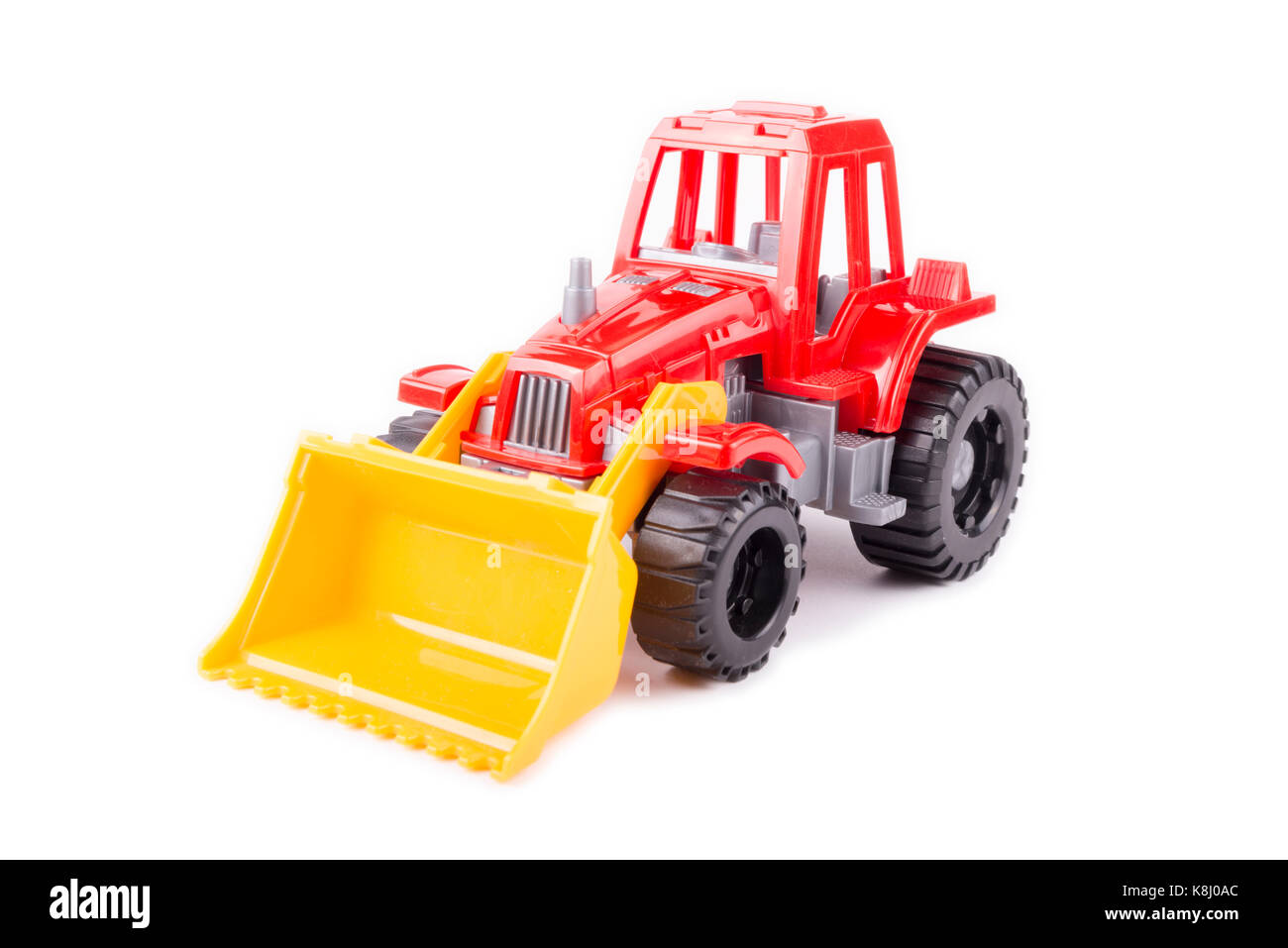 red toy tractor on a white background Stock Photo - Alamy