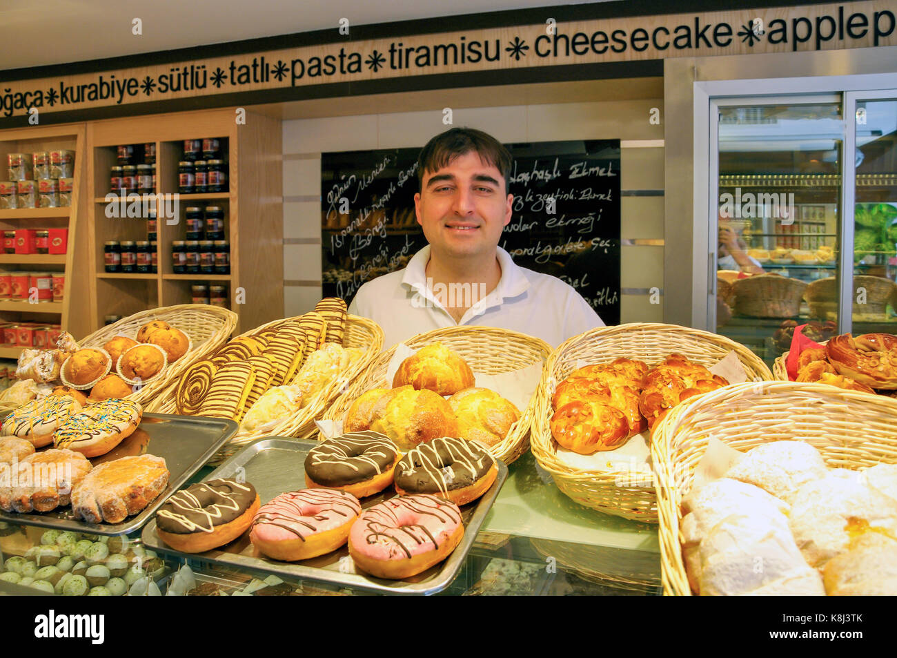 Owner behind counter in Turkish patisserie, Old Bazaar, Bodrum, Bodrum ...