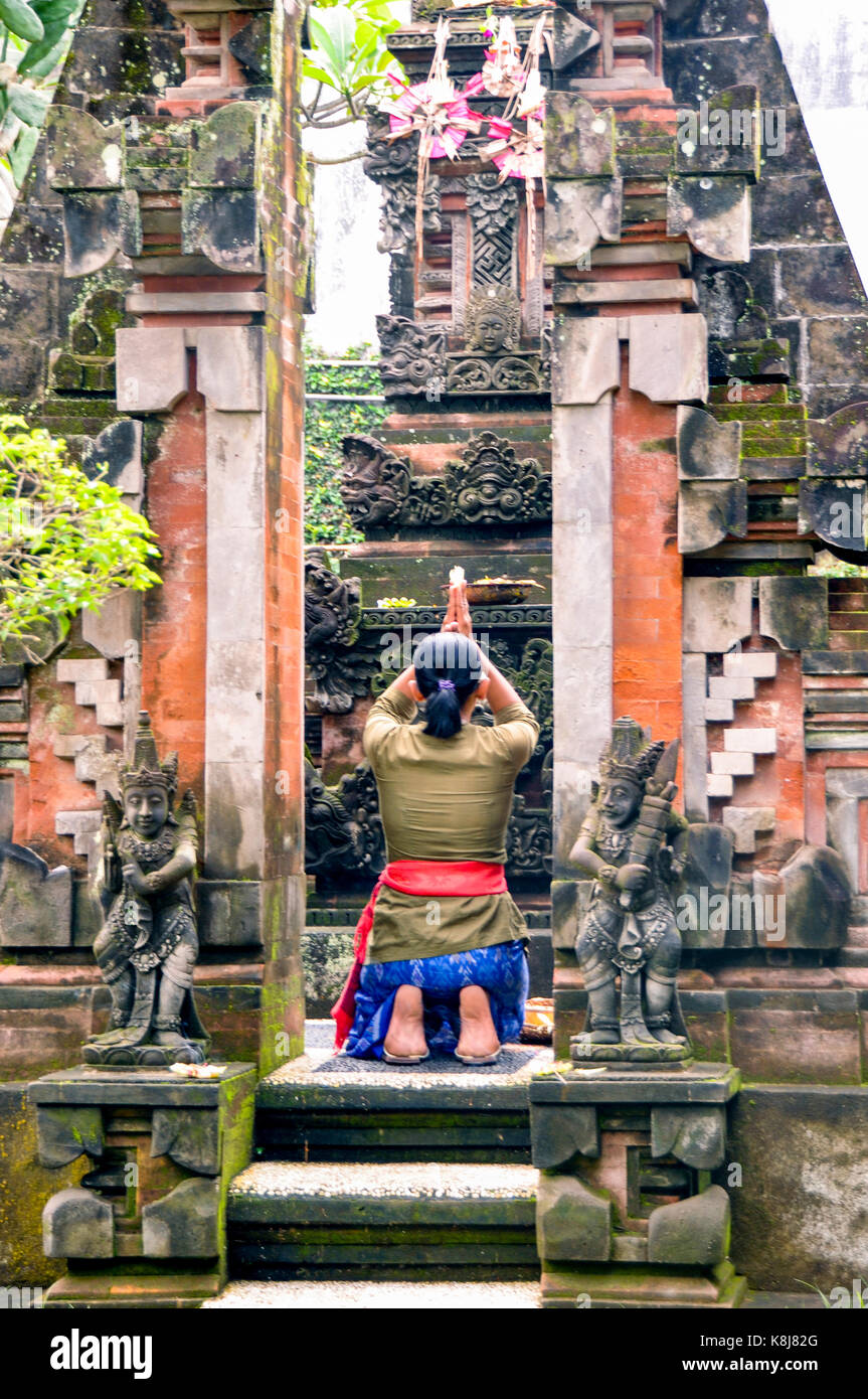 Indonesia. Bali. Ubud. Balinese woman praying in a temple Stock Photo ...