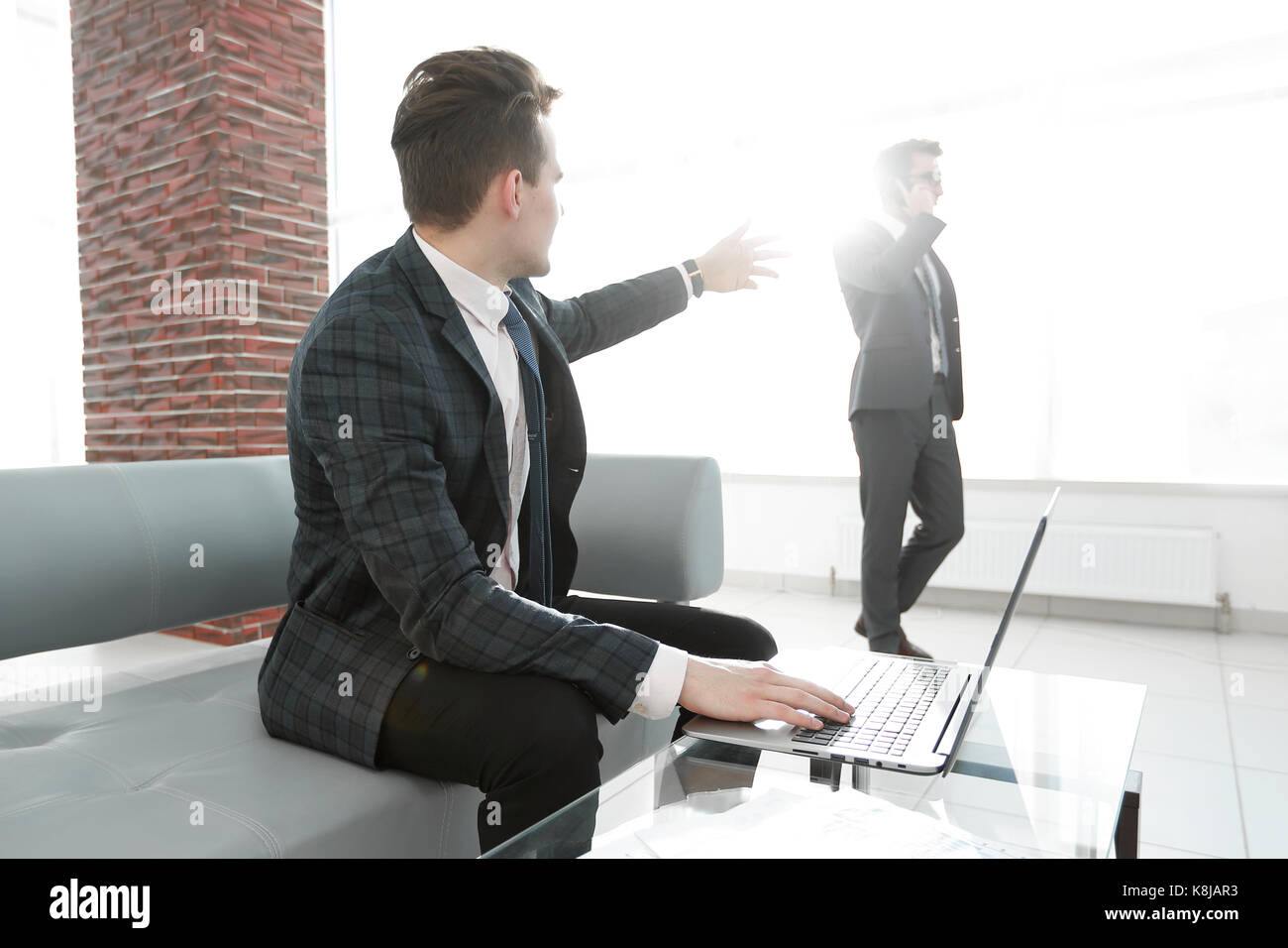 businessman with laptop pointing at the screen Stock Photo - Alamy