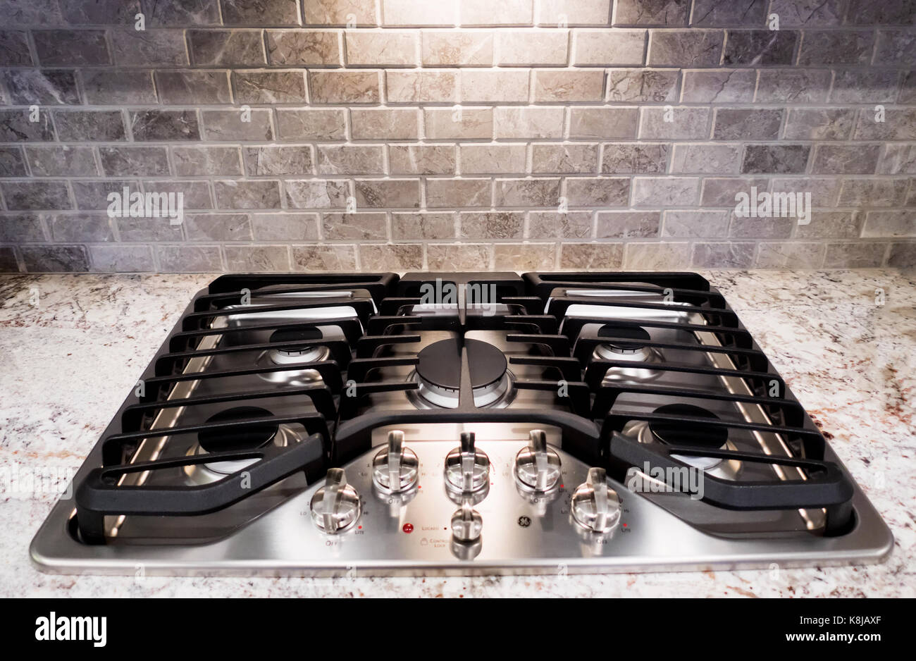 A gas stovetop on a granite countertop Stock Photo - Alamy