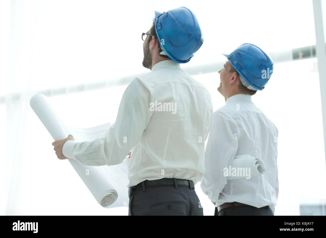 rear view.architect and Builder looking at blank screen Stock Photo - Alamy