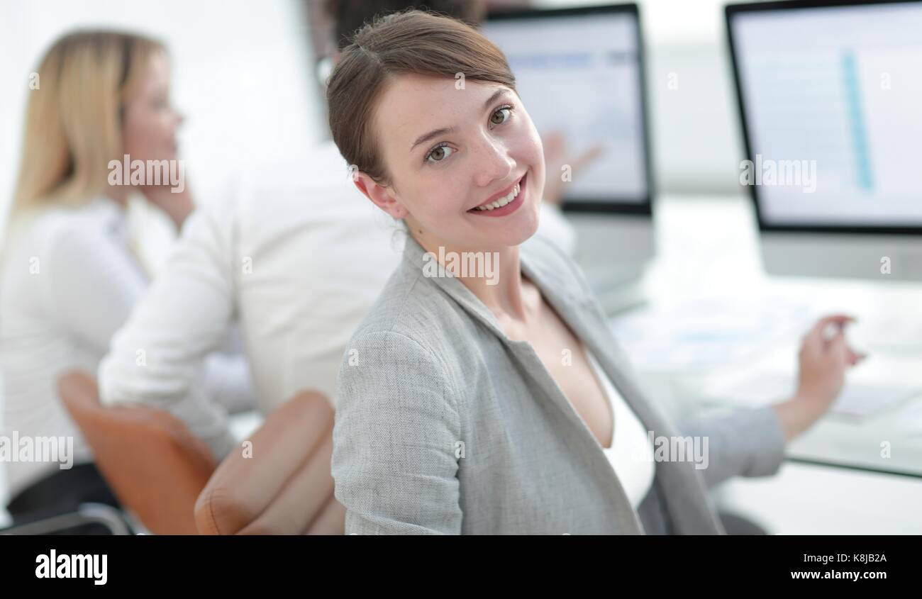 rear view. beautiful business woman sitting near the desktop and ...