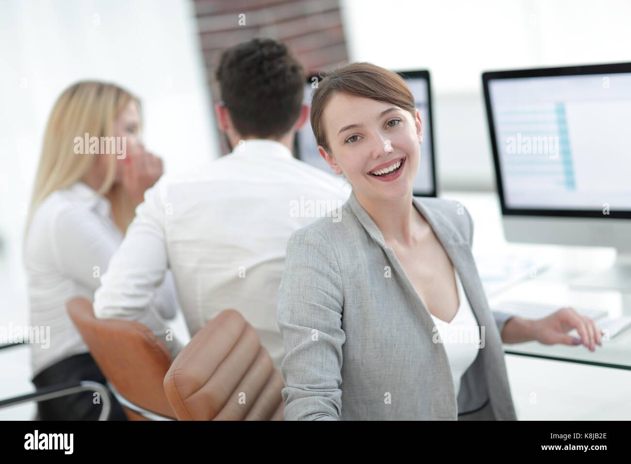 rear view. beautiful business woman sitting near the desktop and ...