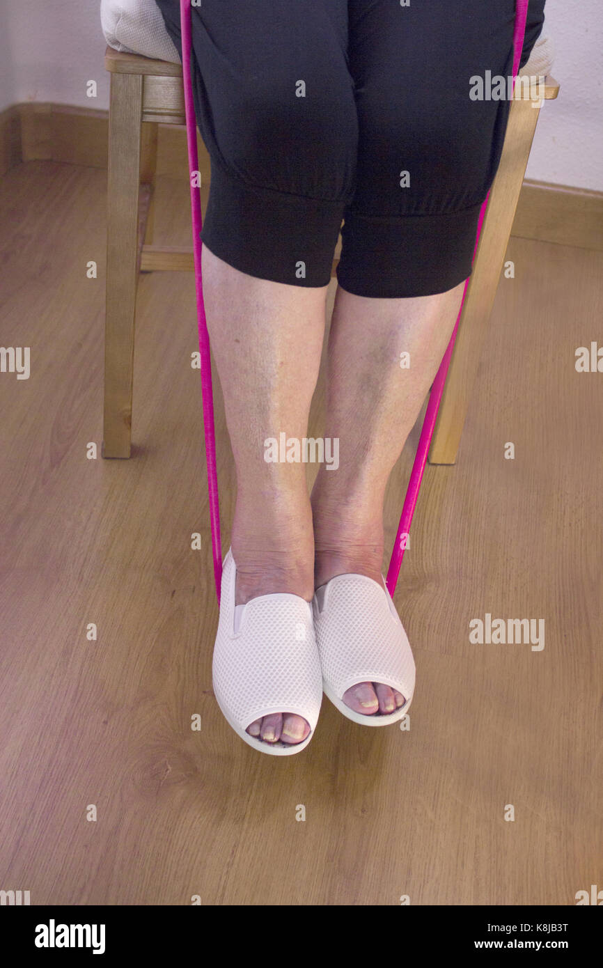 Rehabilitation exercises with elastic resistance rubber for older woman ...