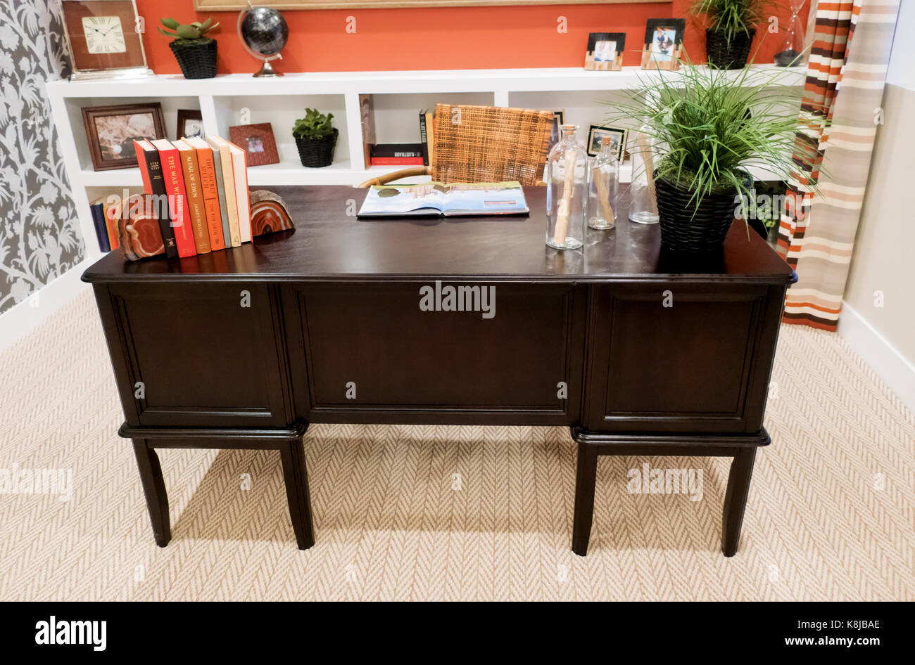 A large brown desk with cubicles and a book open on the desk Stock ...
