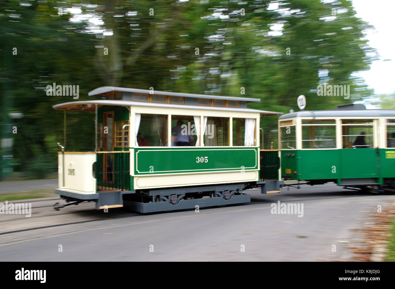 Green historic tram in motion. Old public transportation train in ...
